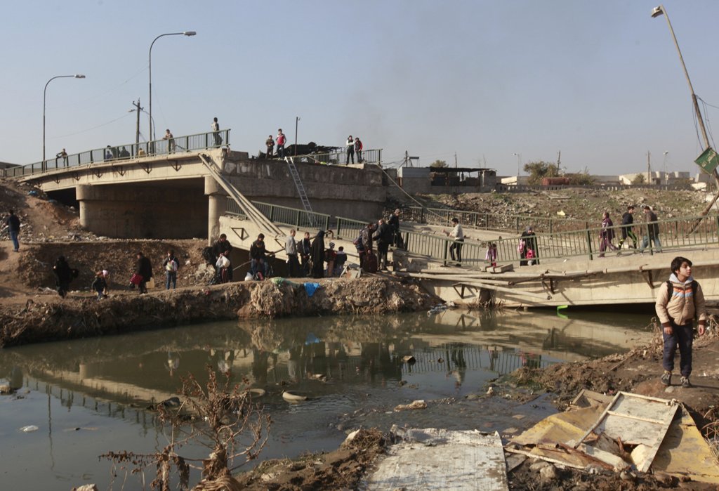 Bombed Mosul bridge still lifeline for long-suffering civilians | The ...
