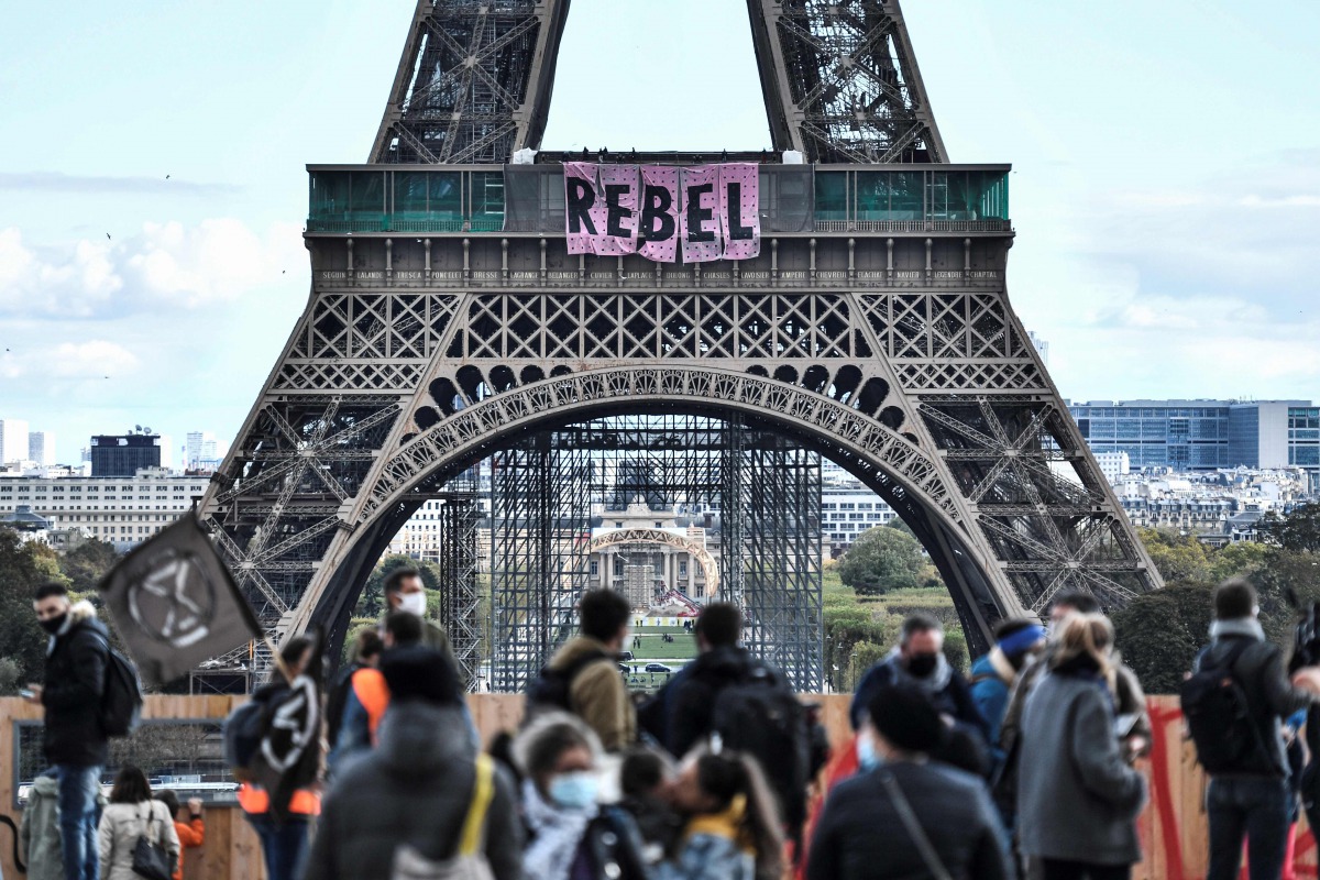 Extinction Rebellion unfurls banner on Eiffel Tower | The Peninsula Qatar