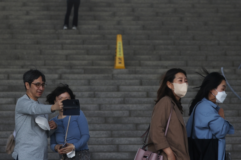 South Korea drops outdoor mask rule but many prefer to keep them on ...